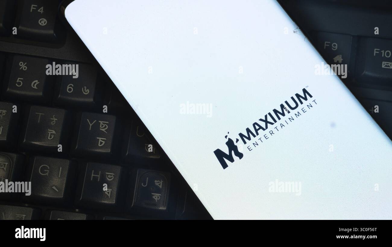 Smartphone on keyboard showing Maximum Entertainment logo Stock Photo ...