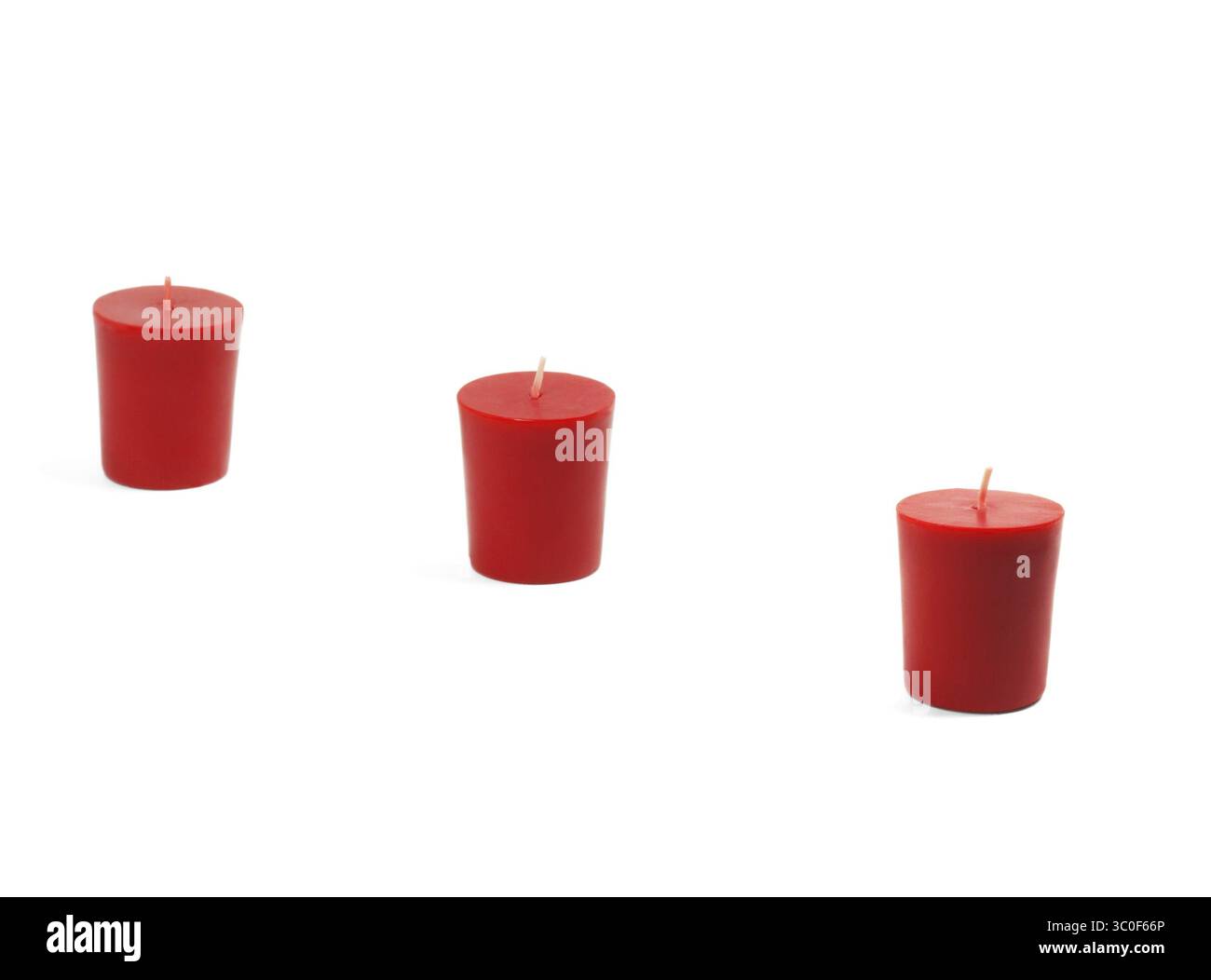 Three red candles isolated on white background Stock Photo - Alamy