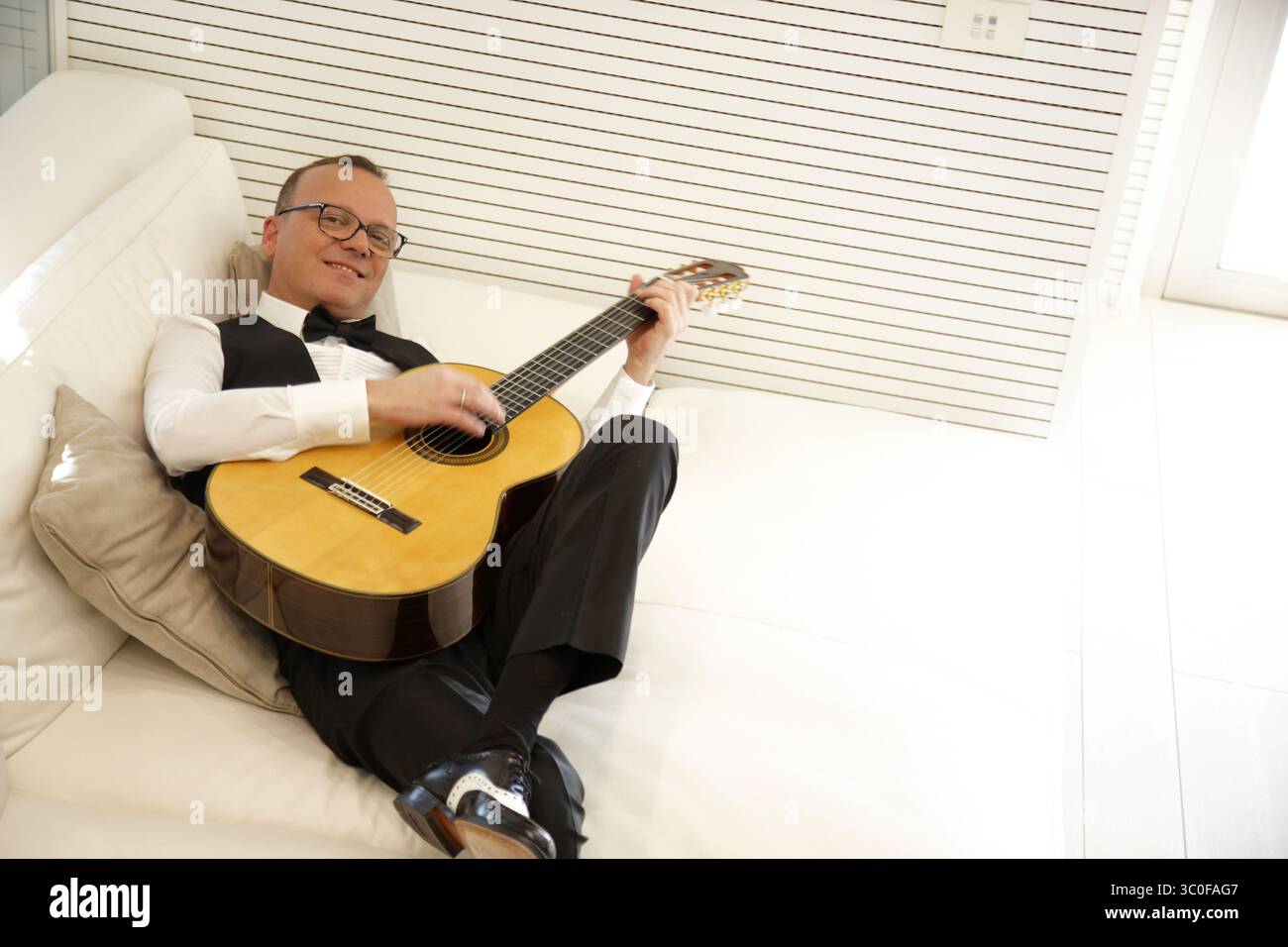 The singer-songwriter Gigi D'Alessio playing the guitar in his house in ...