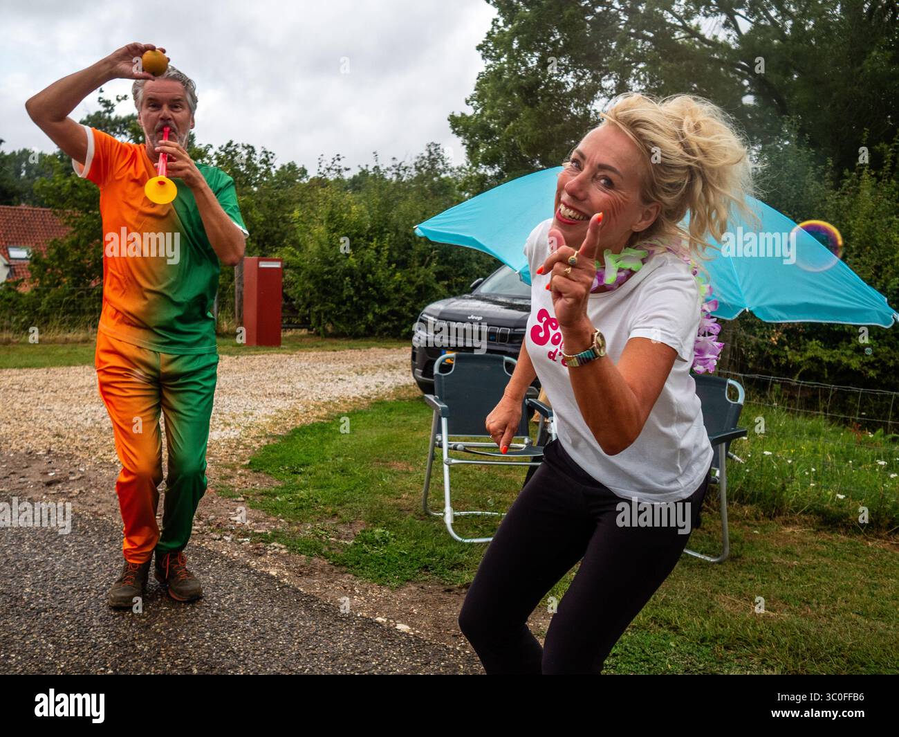A couple is seen dancing to cheer the walkers. The International Four ...