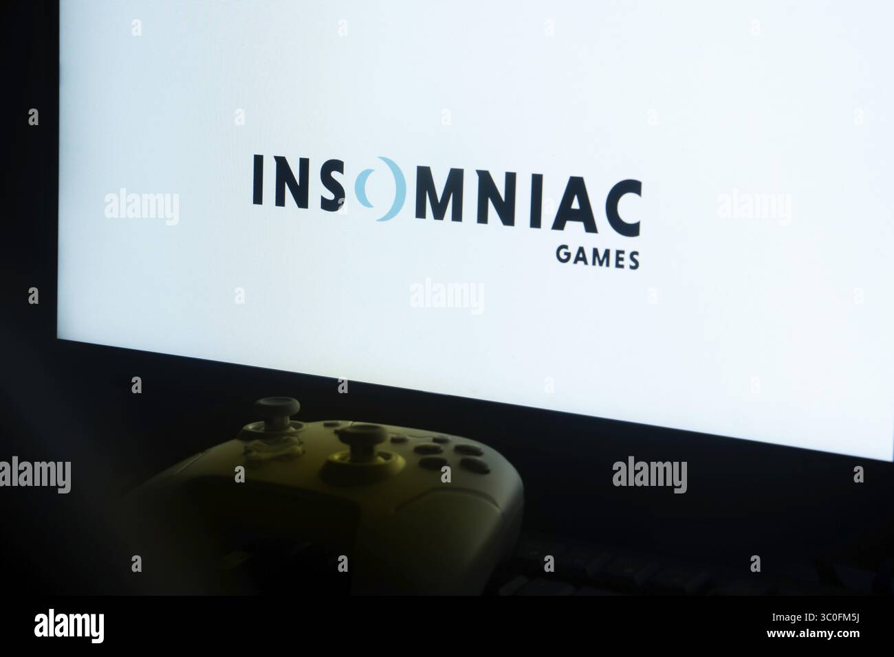 Insomniac Games logo on screen with controller silhouette Stock Photo ...