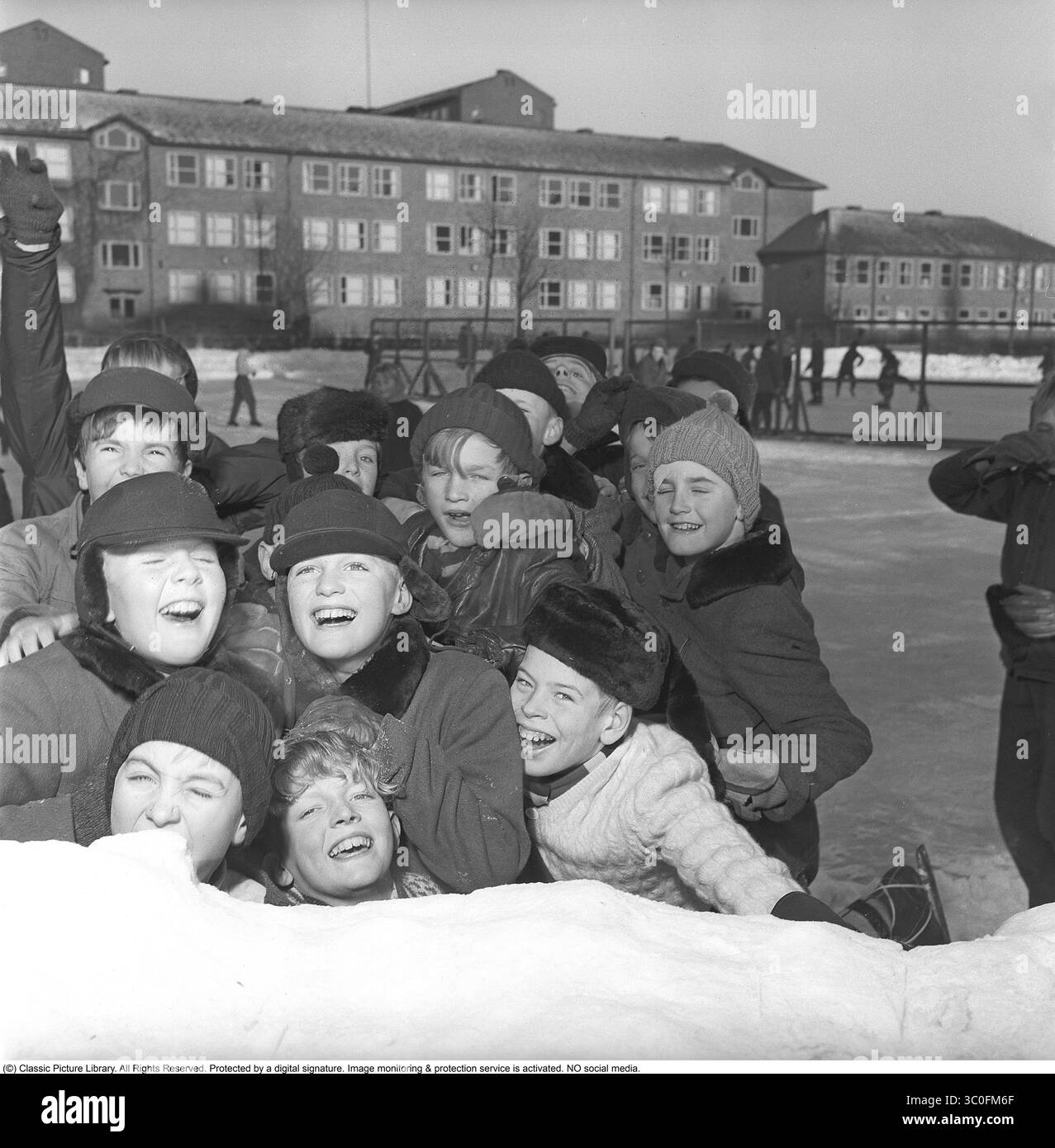 Winter in the 1950s. Children are playing in on the schoolyard. Sweden ...