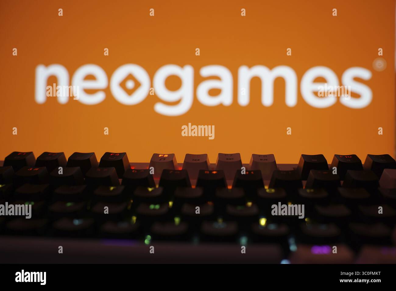 Neogames logo in white on an orange background above a keyboard with ...