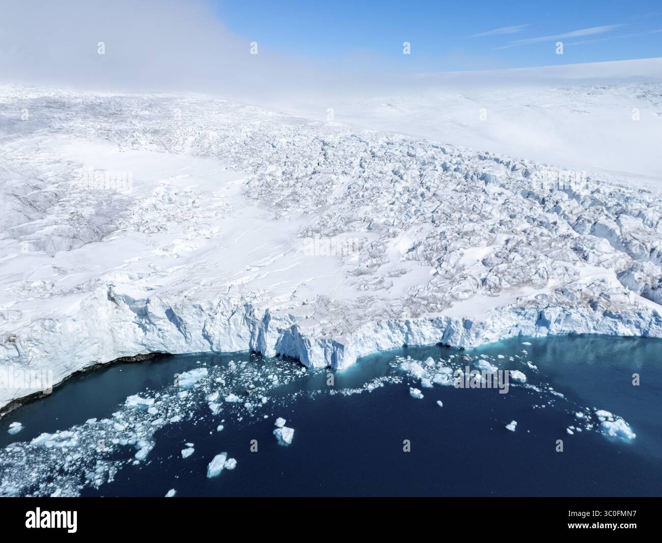 Aerial view of the glacier's icy embrace meets the deep blue sea, a ...