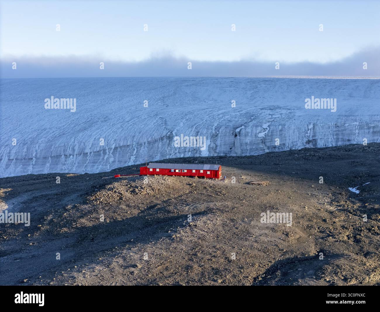 Aerial view of a solitary red structure standing resolute against the ...