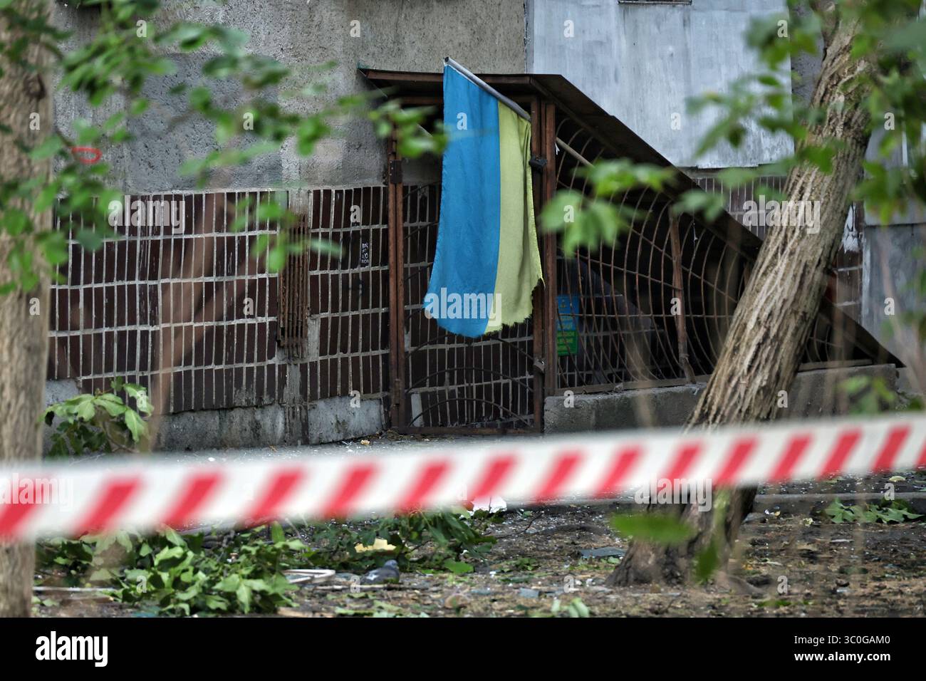 A Ukrainian flag is at an apartment block damaged by a Russian drone ...