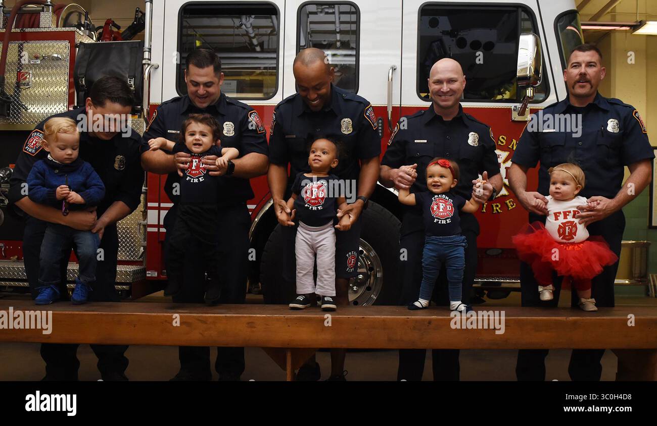 November 12, 2018 - Fresno, CA, USA - From left, Josh Henry holds son ...