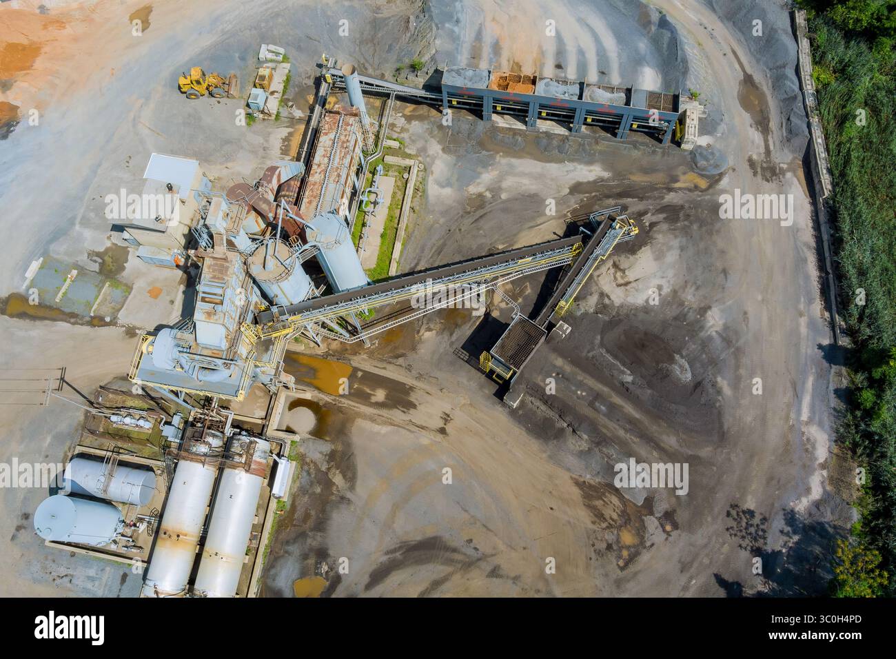 Aerial view of an industrial facility with machinery, storage ...