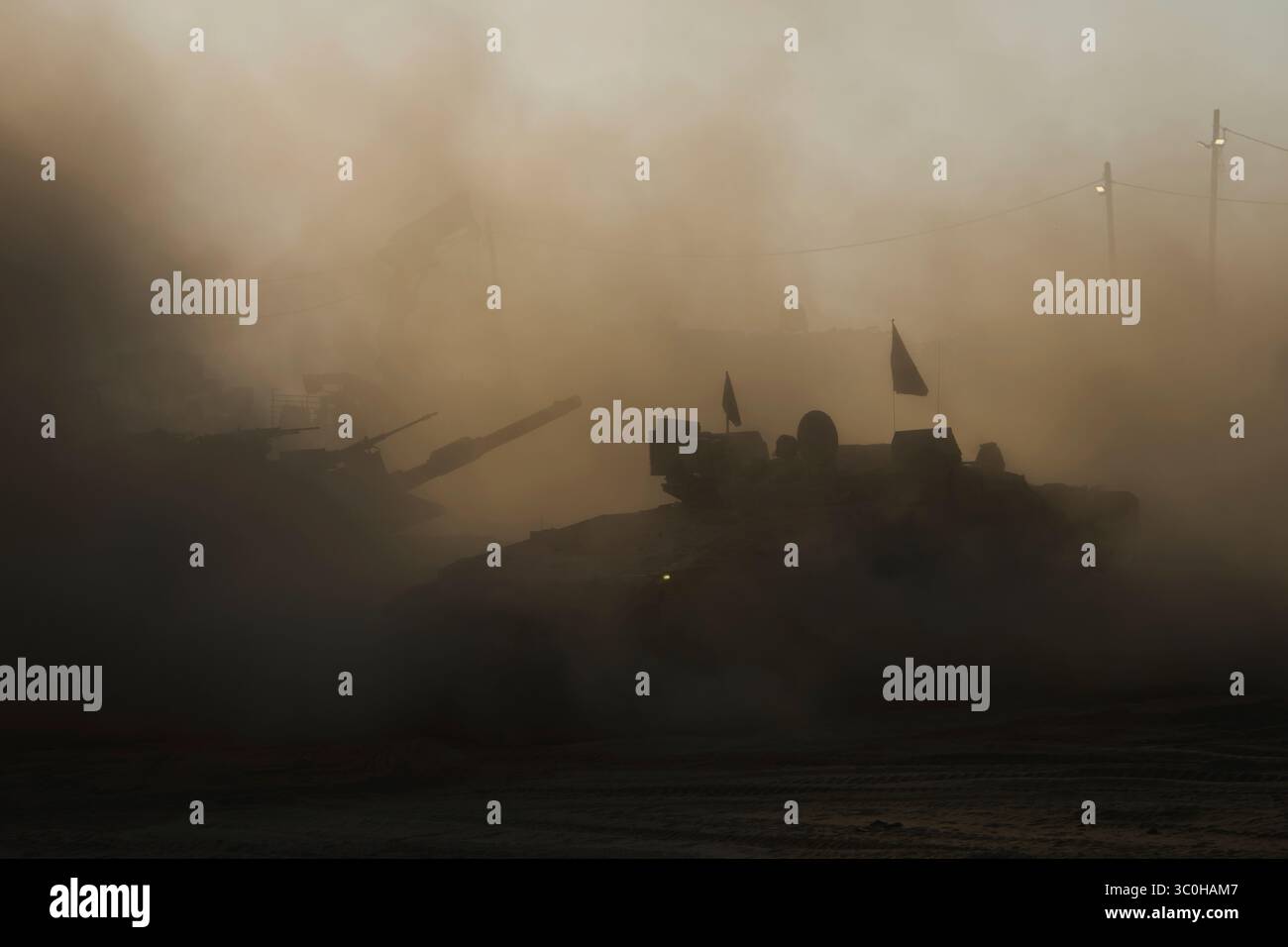 An Israeli military APC drive at a gathering point near the Gaza Strip ...