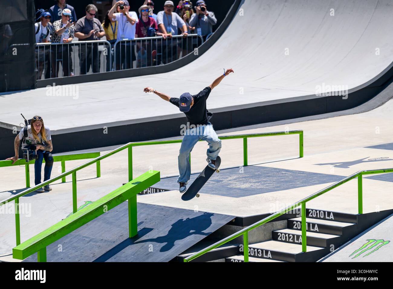 Yuto Horigome, of Japan, kick flips his skateboard to the rail in the Monster Energy Men's ...