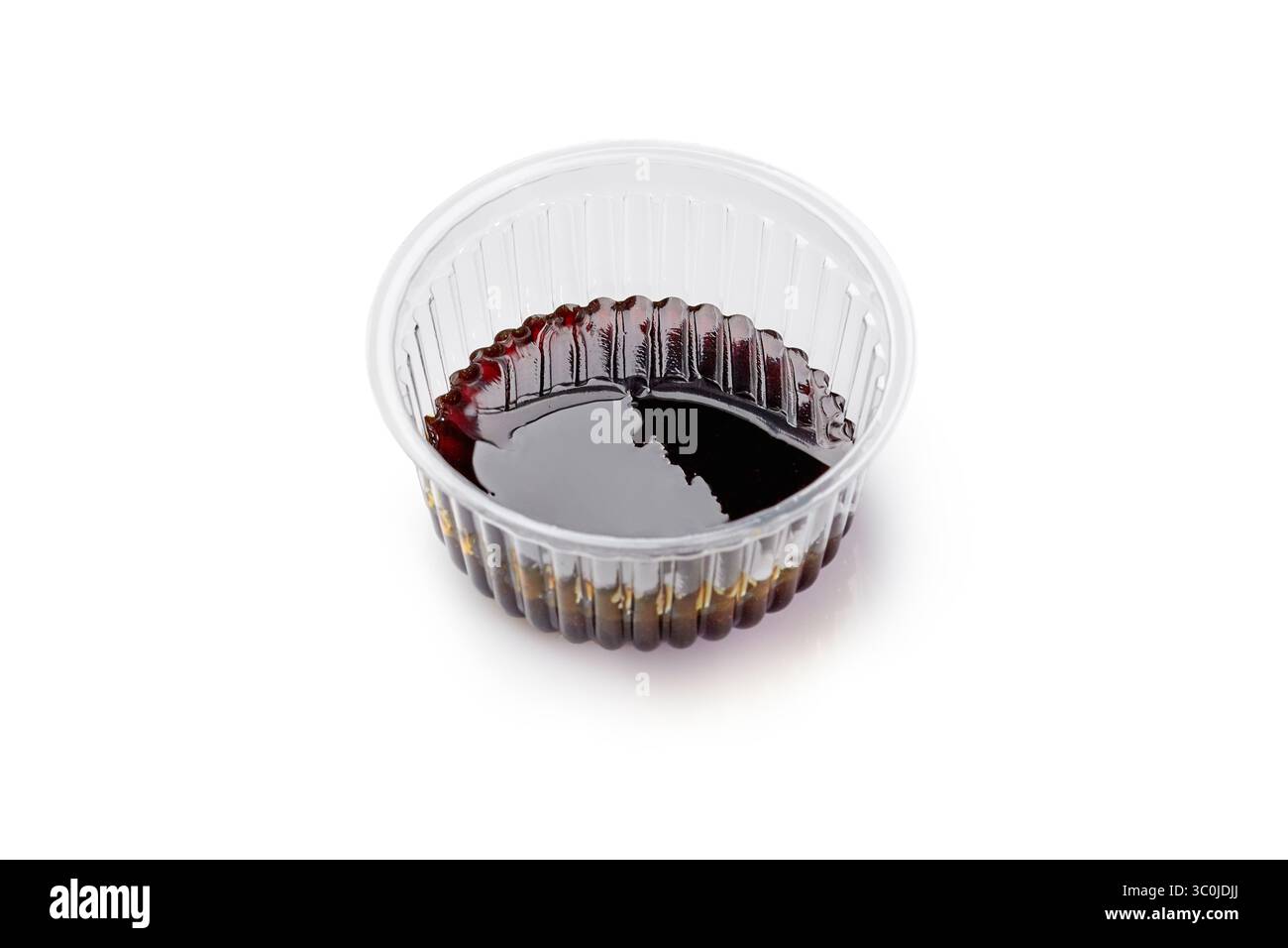 Small plastic container filled with soy sauce, isolated on a white ...