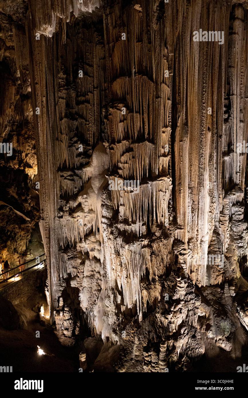 Visitors explore a magnificent underground cave in Malaga, Spain ...