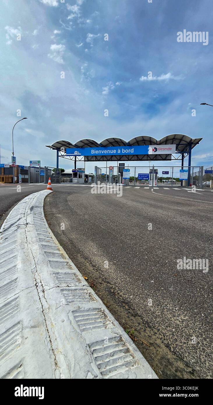 Asphalt road leading to a boarding on the ferry between Verdon-sur-Mer ...