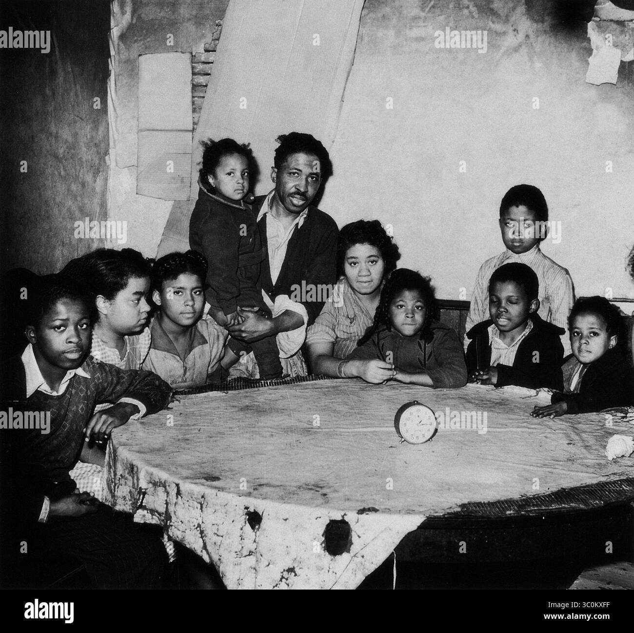 Family of an American Black ghetto sitting gathering around a table ...
