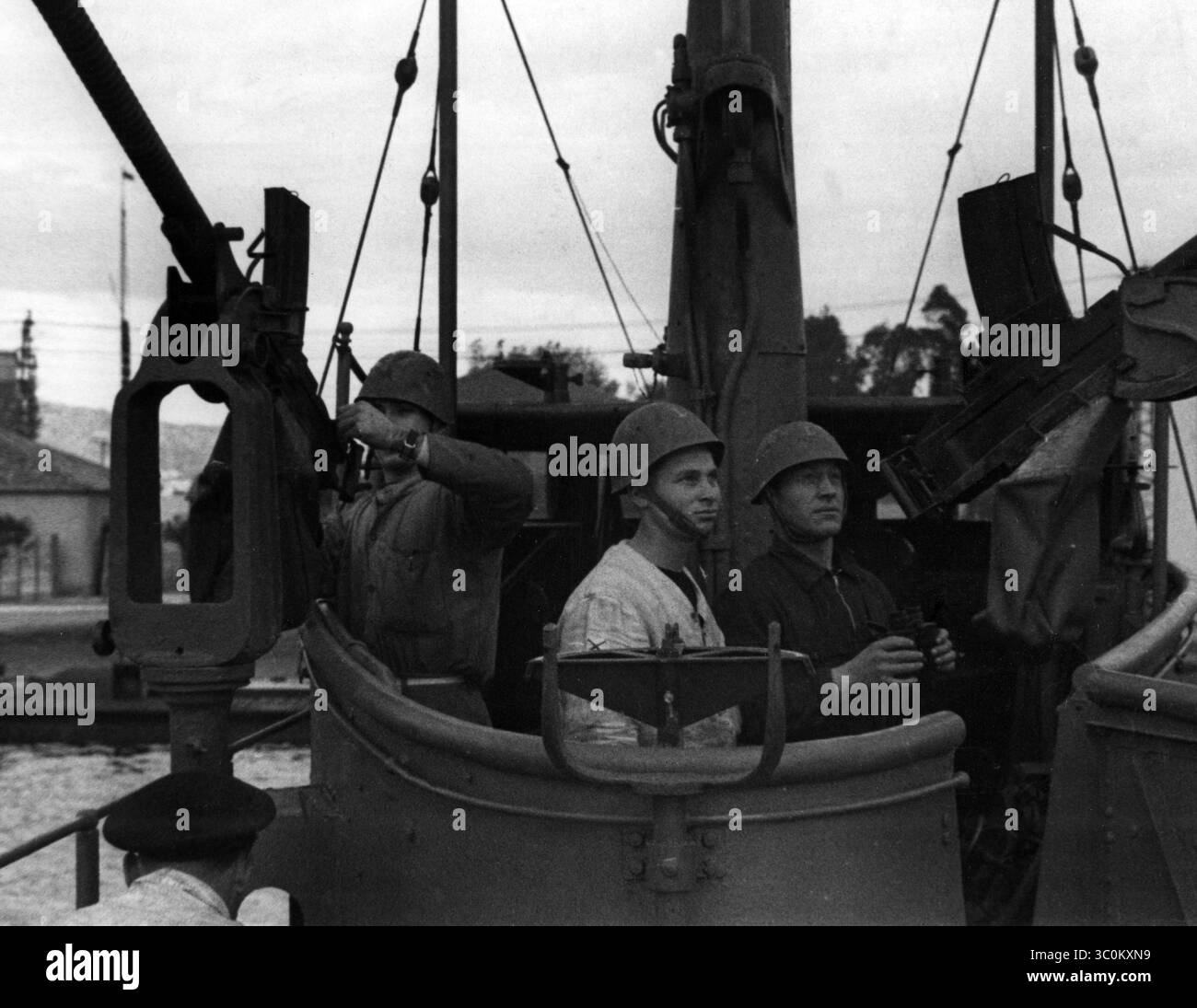 Three Italian machine-gunners keeping lookout on 20 mm calibre anti ...