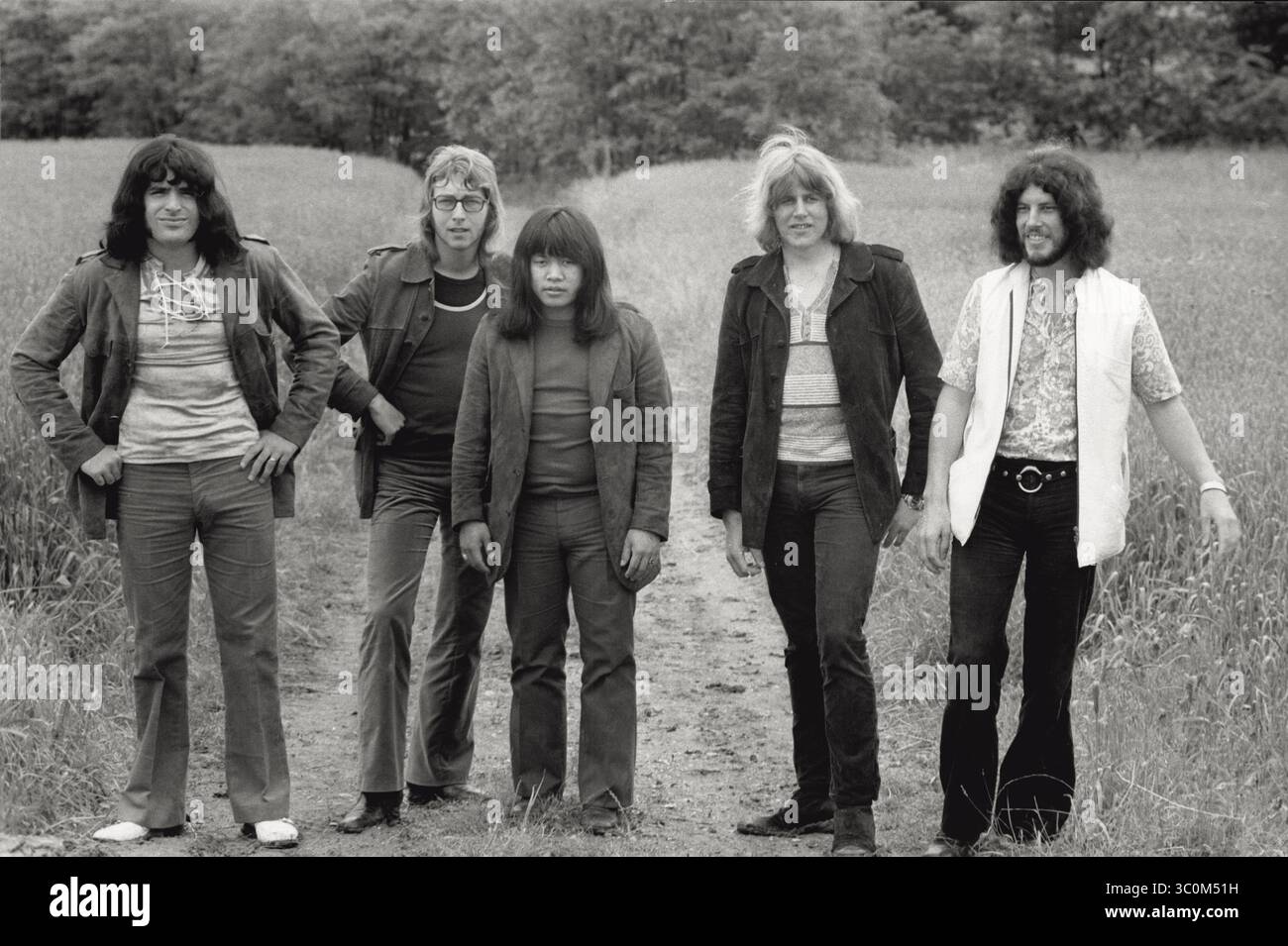The Dutch singer George Baker smiling among the members of his musical ...