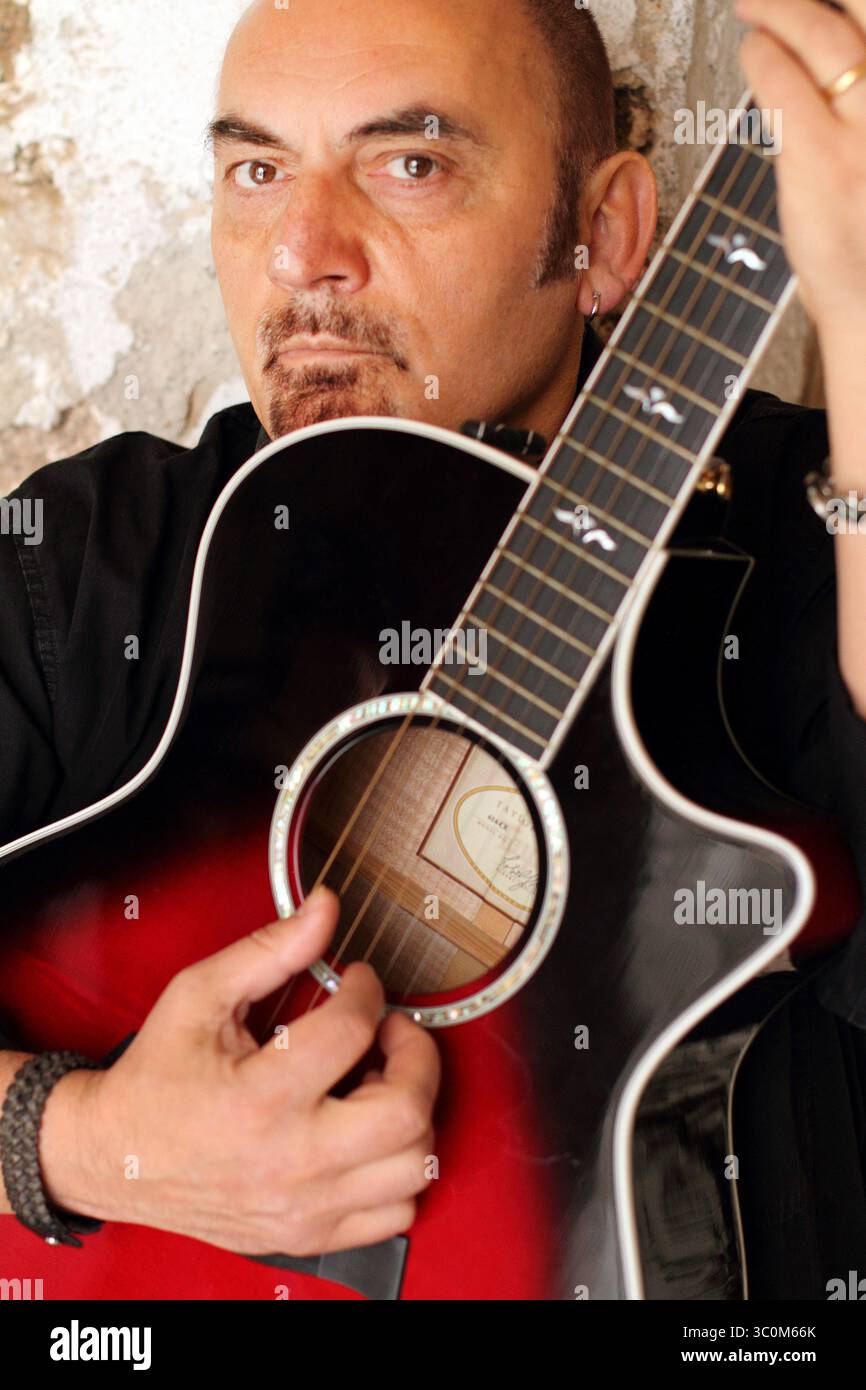 The singer-songwriter Mango, Giuseppe Mango's stage name, playing a ...