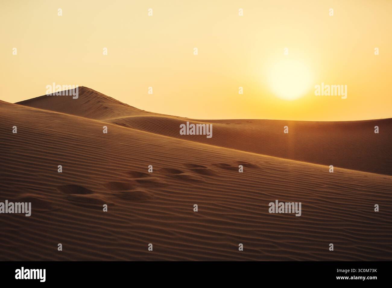 Views of the Dubai desert at sunset, footprints in the sand, with wind ...
