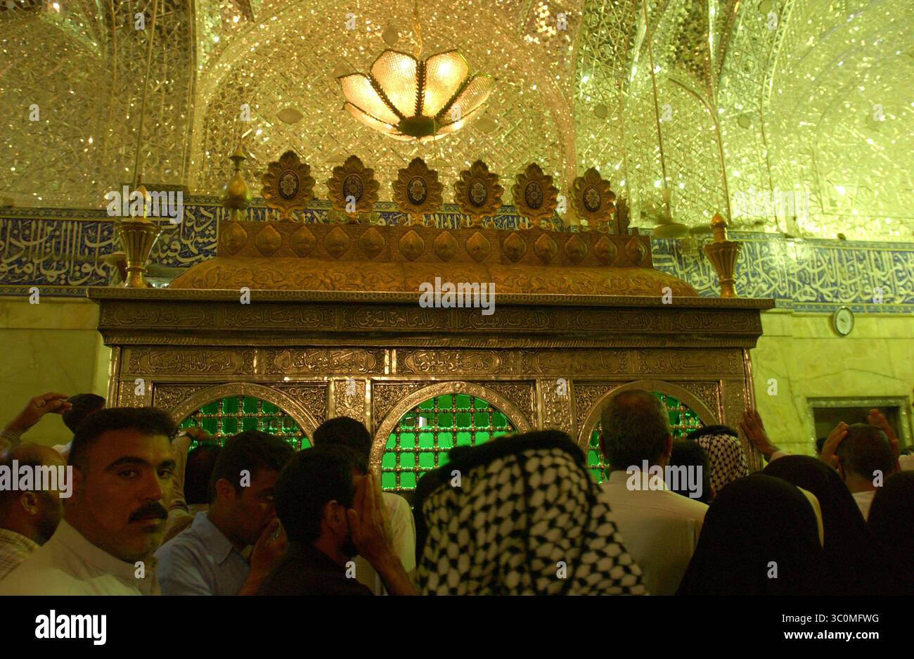 Shiite believers praying in the Imam ?Ali's mosque in a photo shooting ...