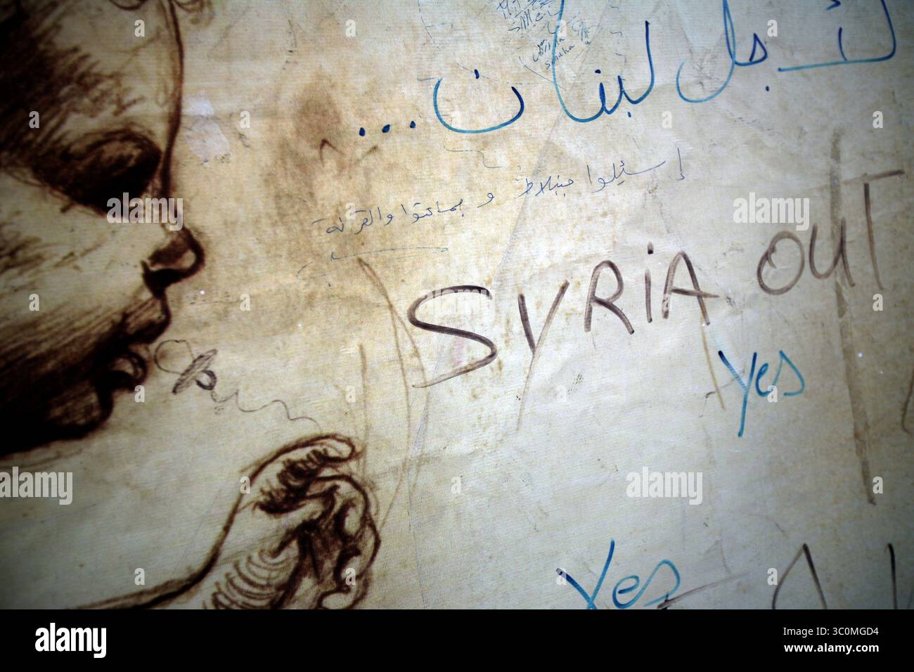 A wall with a drawing depicting a newborn beside a writing against the ...