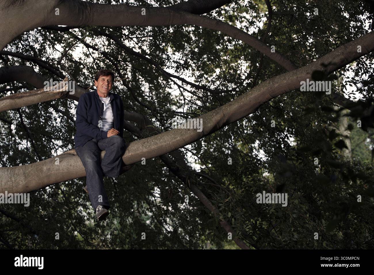 Italian singer and presenter Gianni Morandi sits smiling on the big ...