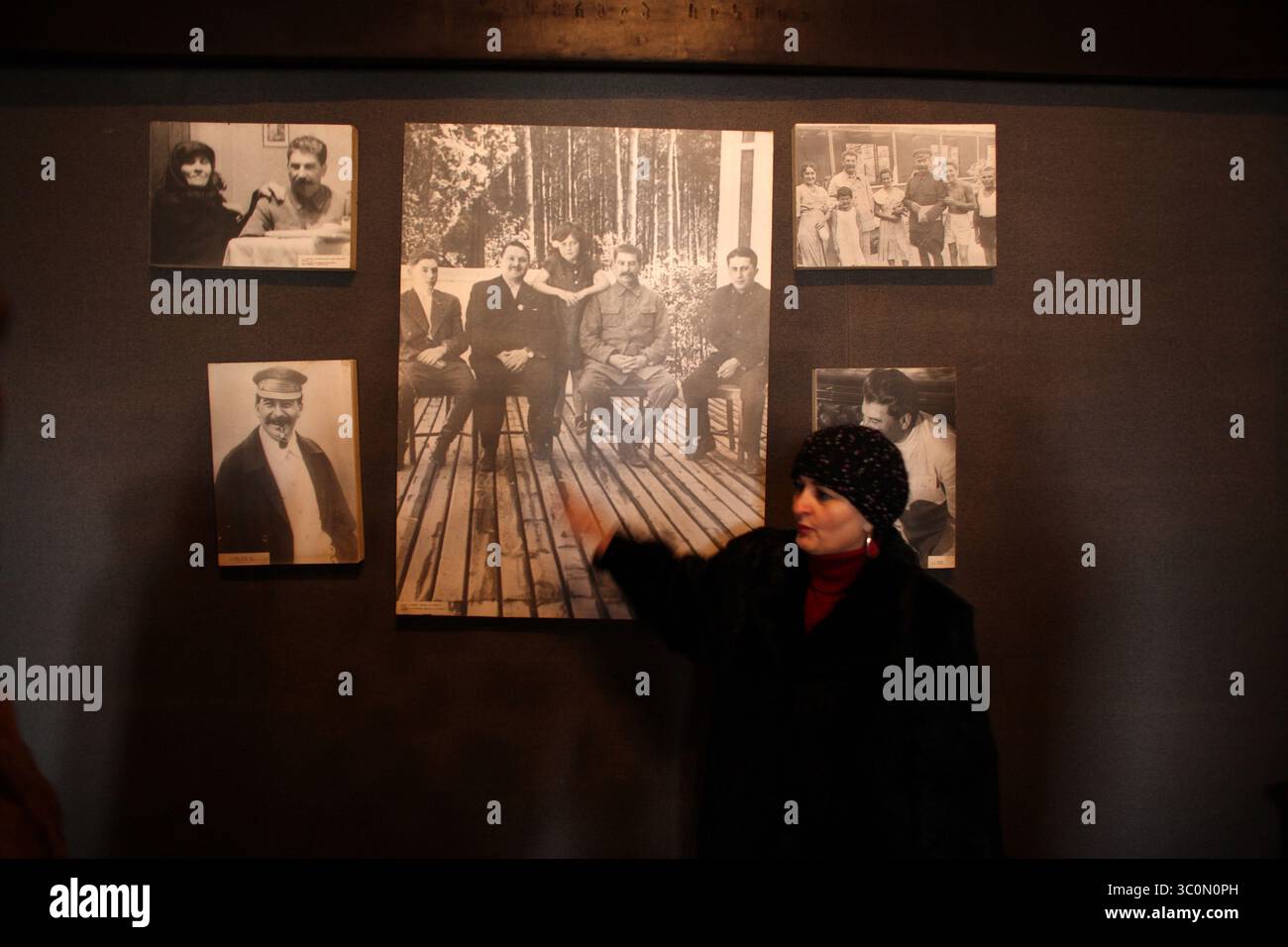 A guide shows some pictures of Joseph Stalin displayed at the museum ...