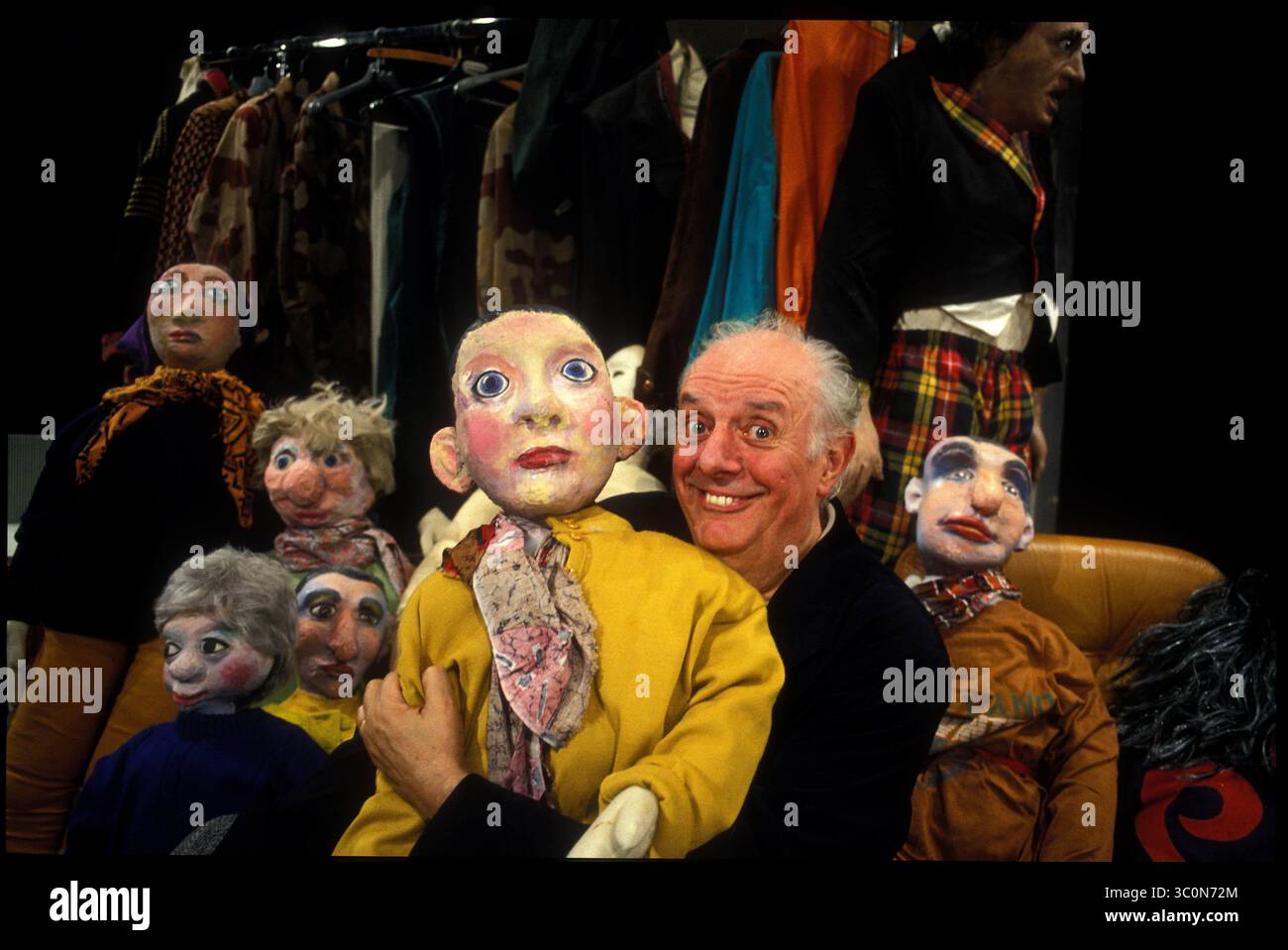 Stage actor Dario Fo posing in his home with several puppets owned by ...