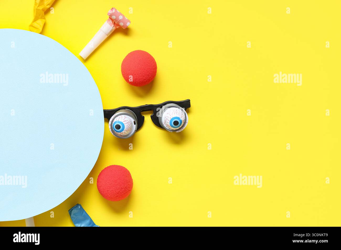 Blank card with funny glasses, clown noses and party decor on yellow ...