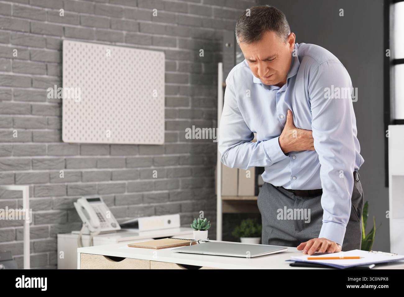 Man chest pain at work hi-res stock photography and images - Alamy