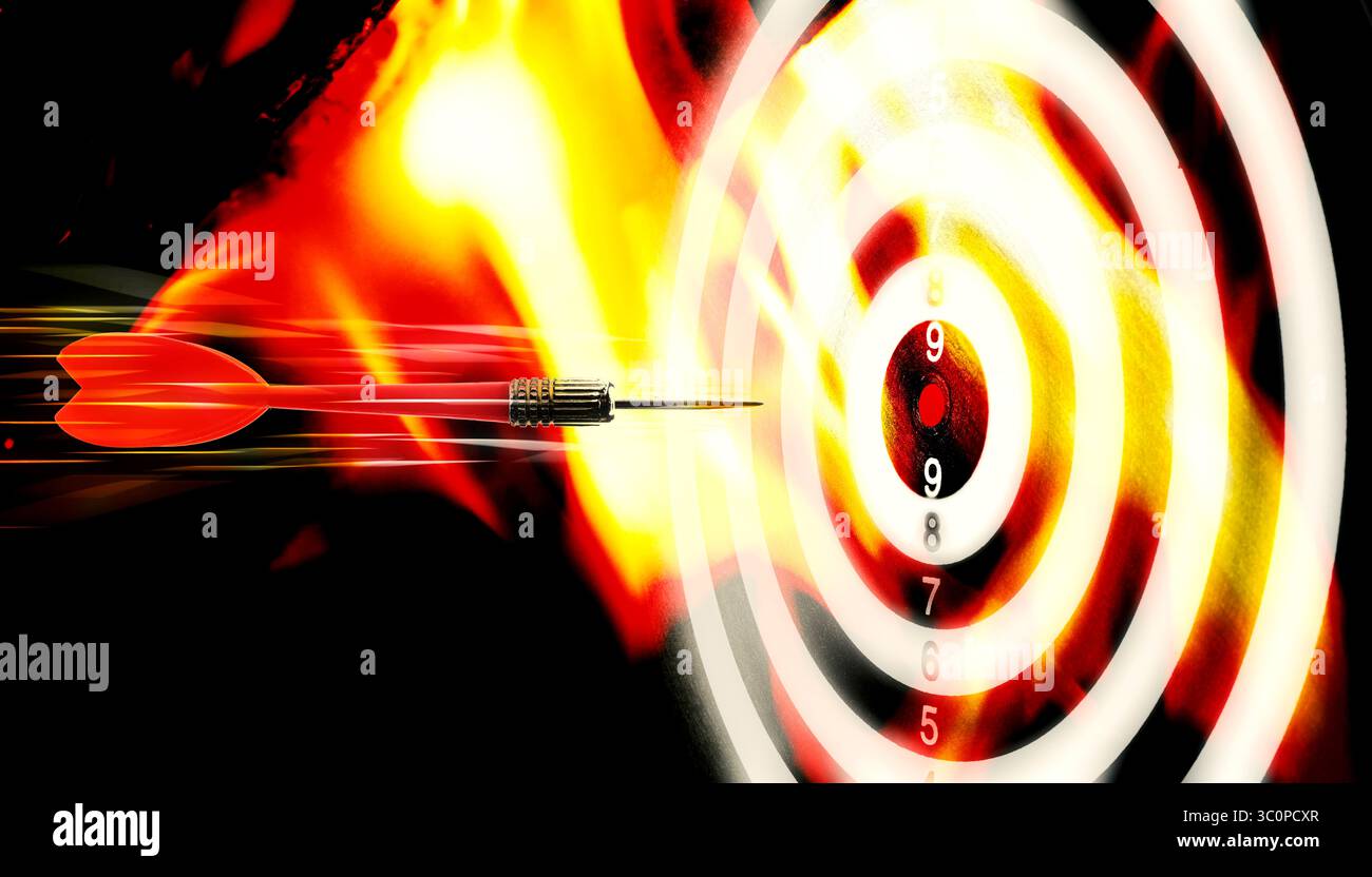 Dart flying into center of flaming target against black background ...