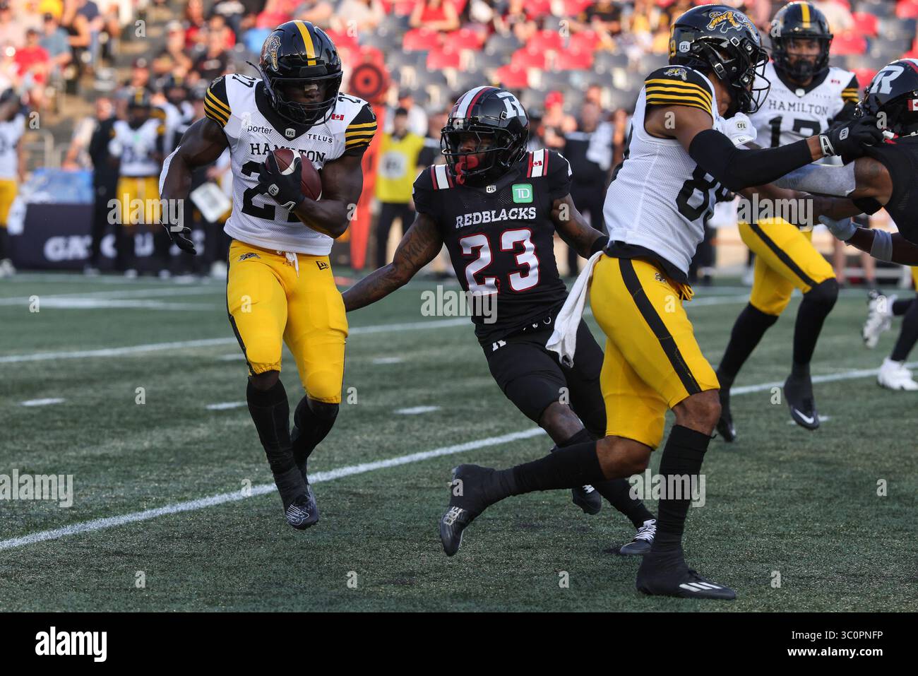 July 20, 2025: Hamilton Tiger-Cats running back Johnny Augustine (27) runs with the ball during ...