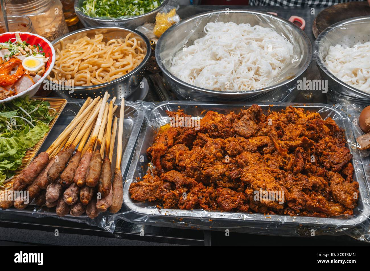 traditional Vietnamese food and meat on counter at Asian night market ...