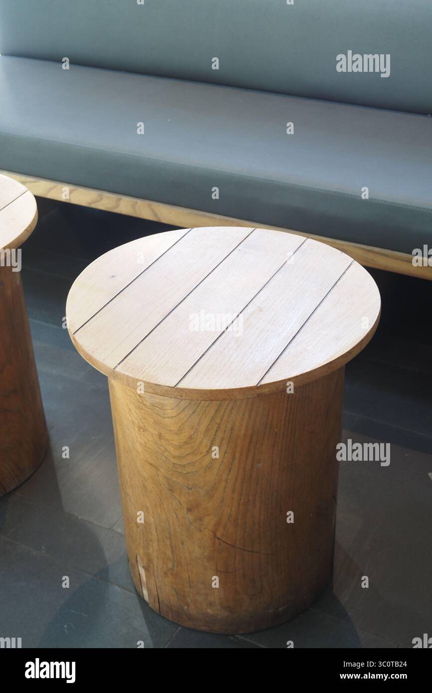 Wooden round table and seating in modern cafe setup Stock Photo - Alamy
