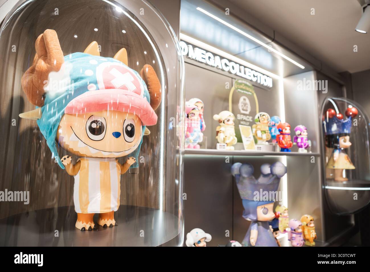 A Labubu figure in a Chopper costume stands encased under a clear dome ...