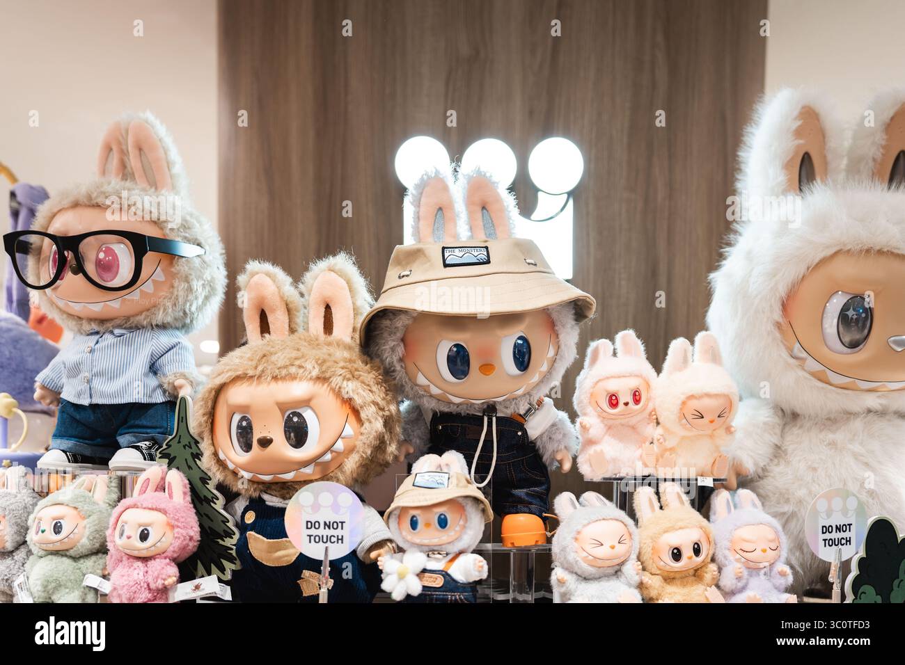 Labubu dolls in various outfits are neatly displayed inside a Pop Mart ...