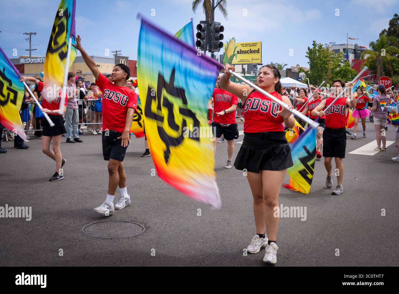 Marchers from SDSU’s color guard team perform a flag routine wearing ...