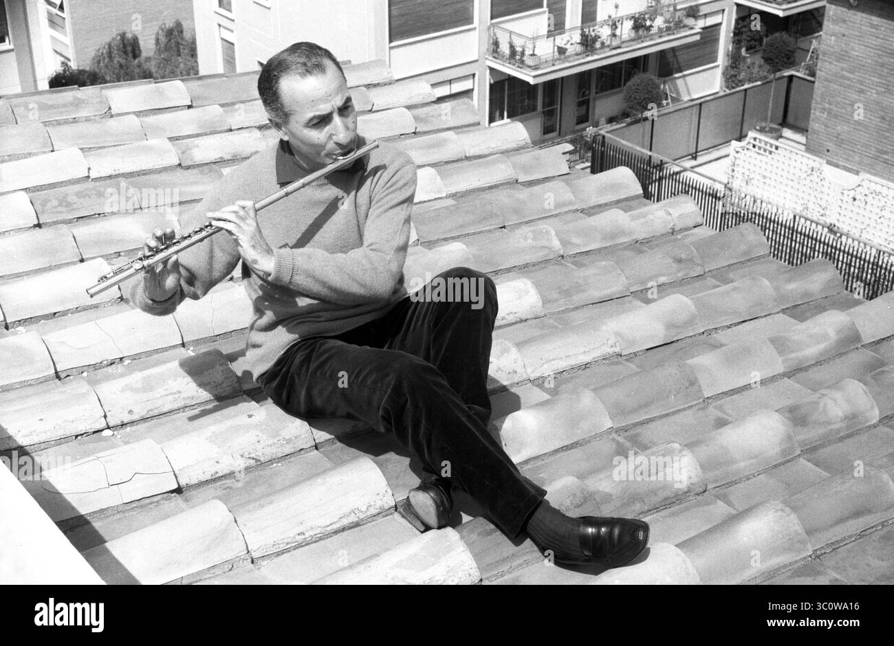 The famous Italian flute player Severino Gazzelloni is seated on the ...