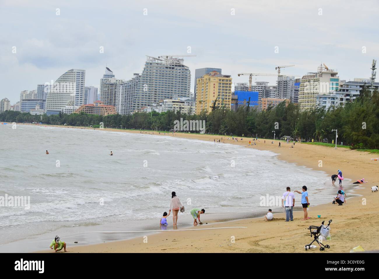 Tourists play at the seaside in Sanya City, southernmost China's Hainan ...