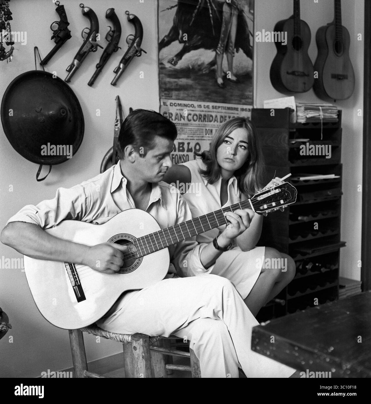 Italian singer-songwriter Sergio Endrigo playing the guitar in the ...