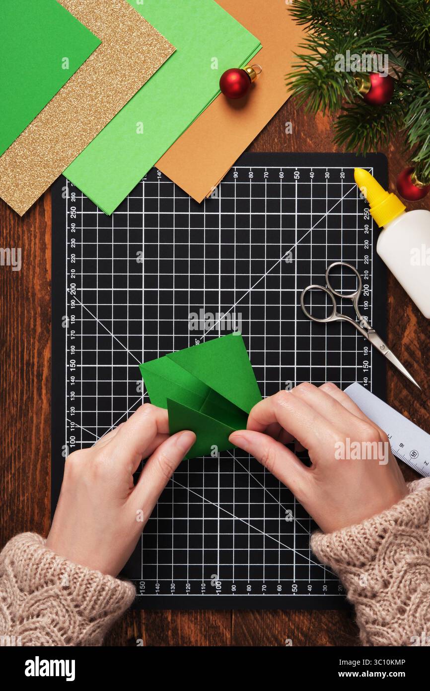 Let's make a simple paper craft. A Christmas tree bookmark. Hands fold ...