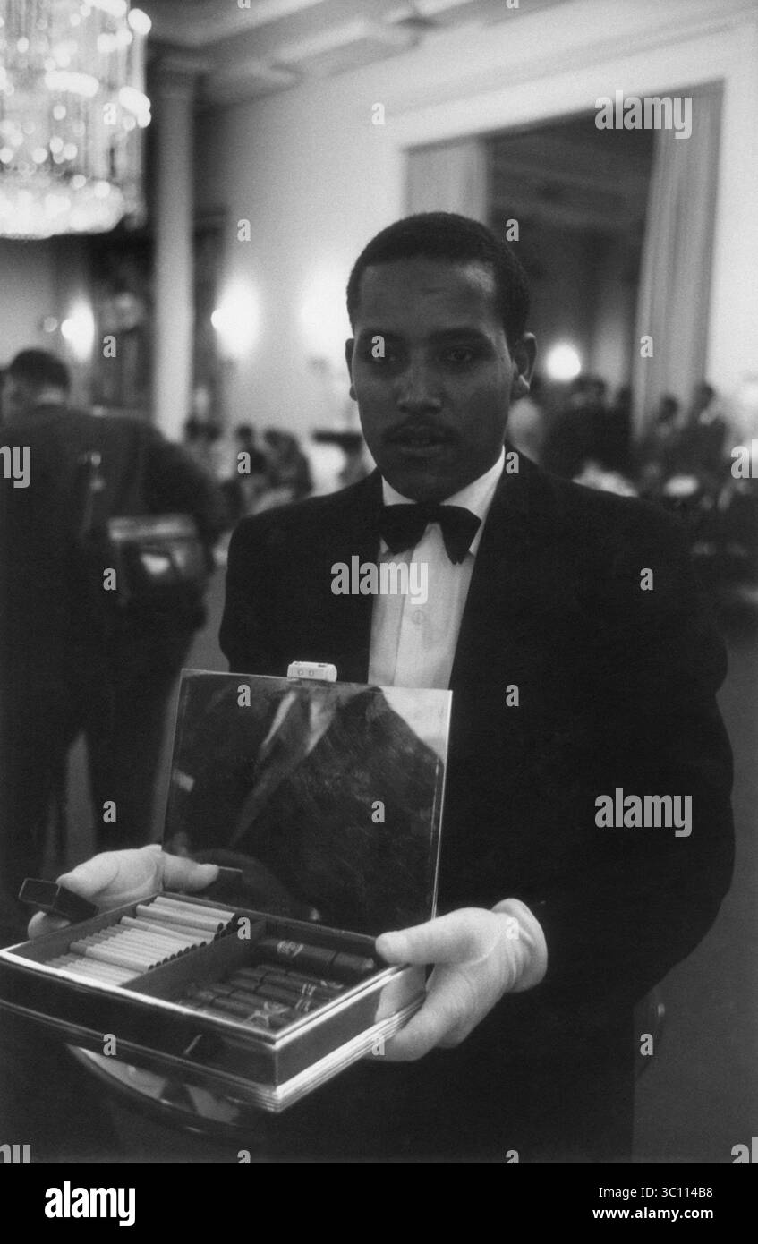 In the Imperial Palace an Ethiopian waiter offering cigars to the ...
