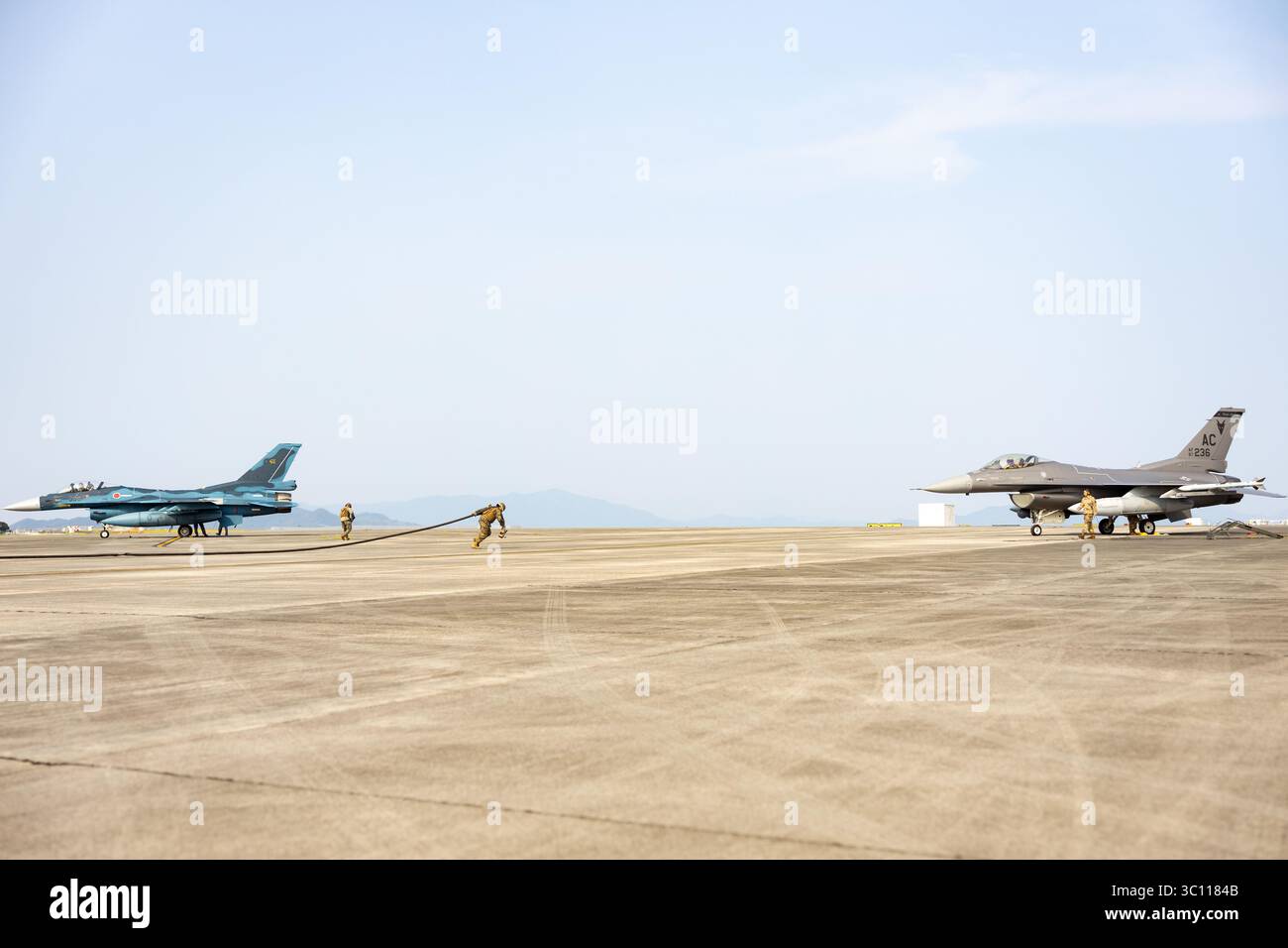 U.S. Marines assigned to MCAS Iwakuni prepare to refuel a U.S. Air ...