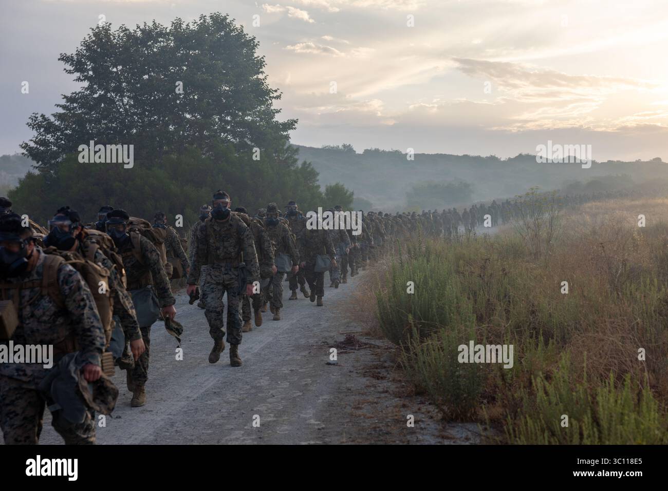 U.S. Marines with Headquarters Battalion, 1st Marine Division, hike as ...