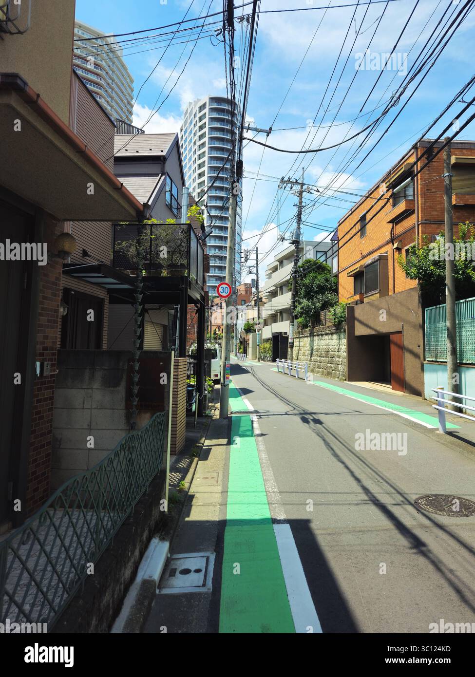 Tokyo Nakano City Residential Street with Overhead Wires and Green Bike ...