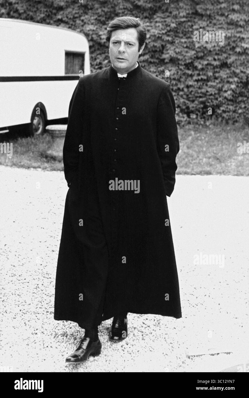 Italian actor Marcello Mastroianni walking dressed as a priest in the ...
