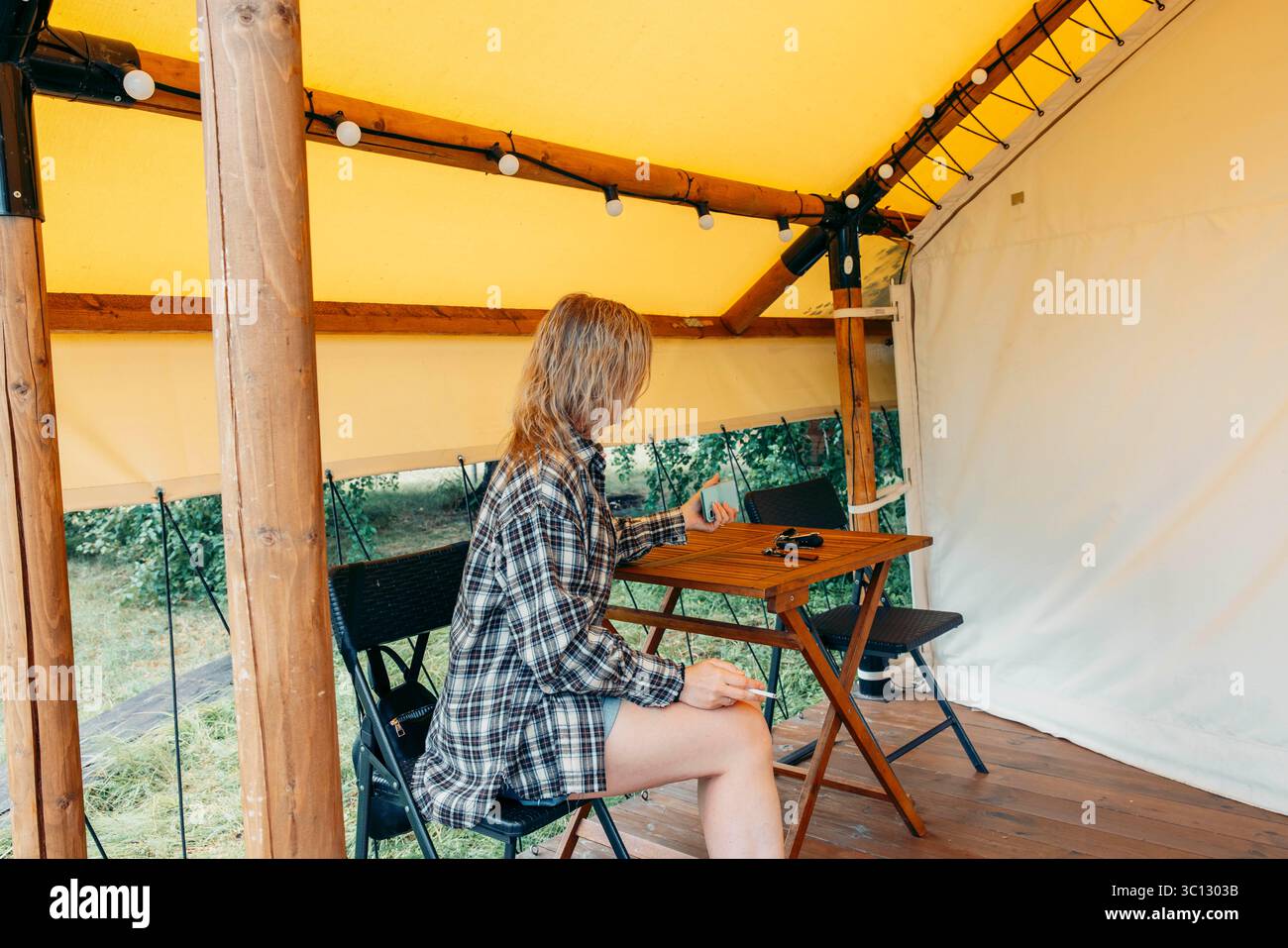 Woman sitting inside glamping hi-res stock photography and images - Alamy