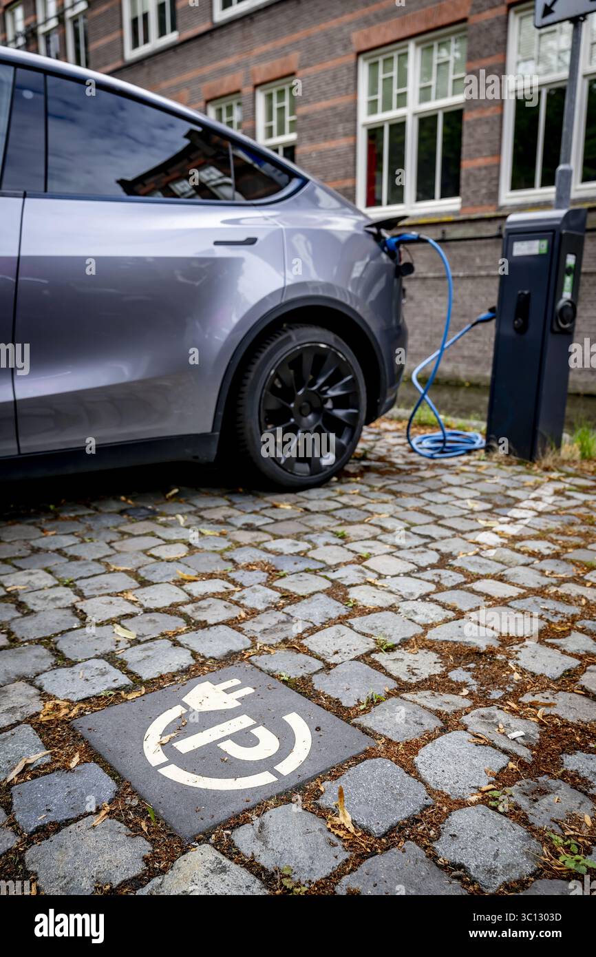 GOUDA - Eletric car charging at a street charging station. One-third of ...