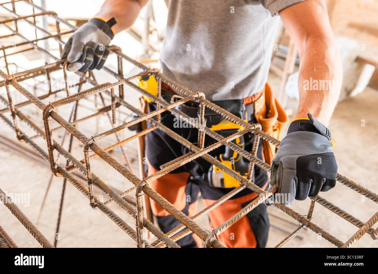 Construction worker carefully assembling hi-res stock photography and ...