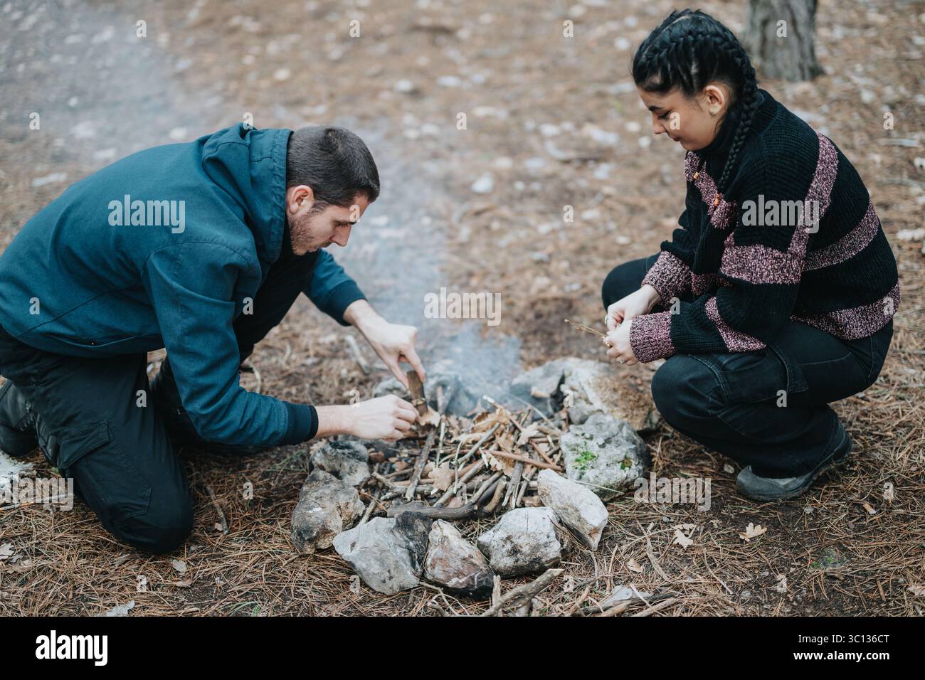 Two People Preparing a Campfire in an Outdoor Forest Setting Stock ...