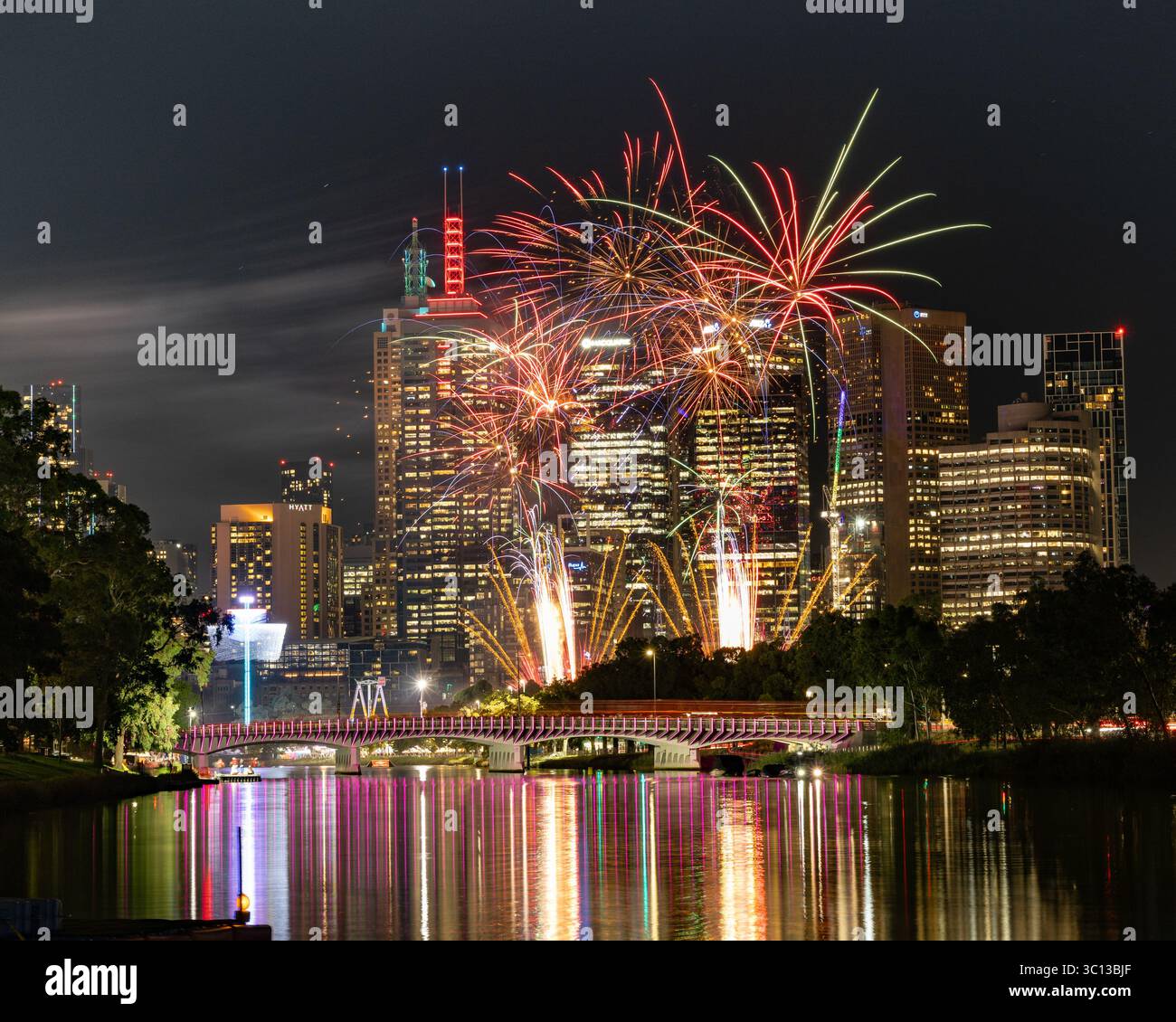 The image shows a section of the Melbourne skyline with a fireworks ...